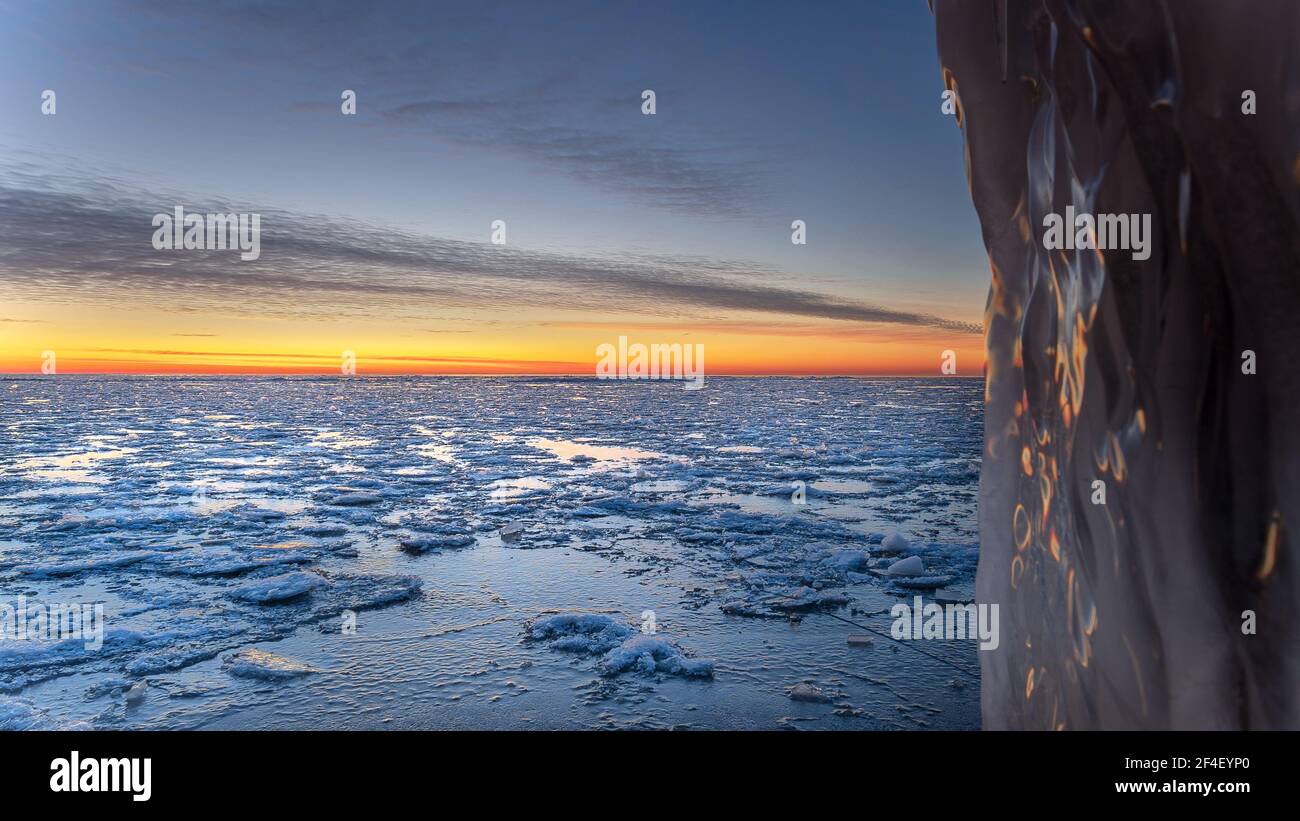 Winter landscape in beach, coastline with cracked ice, snow and opened ...