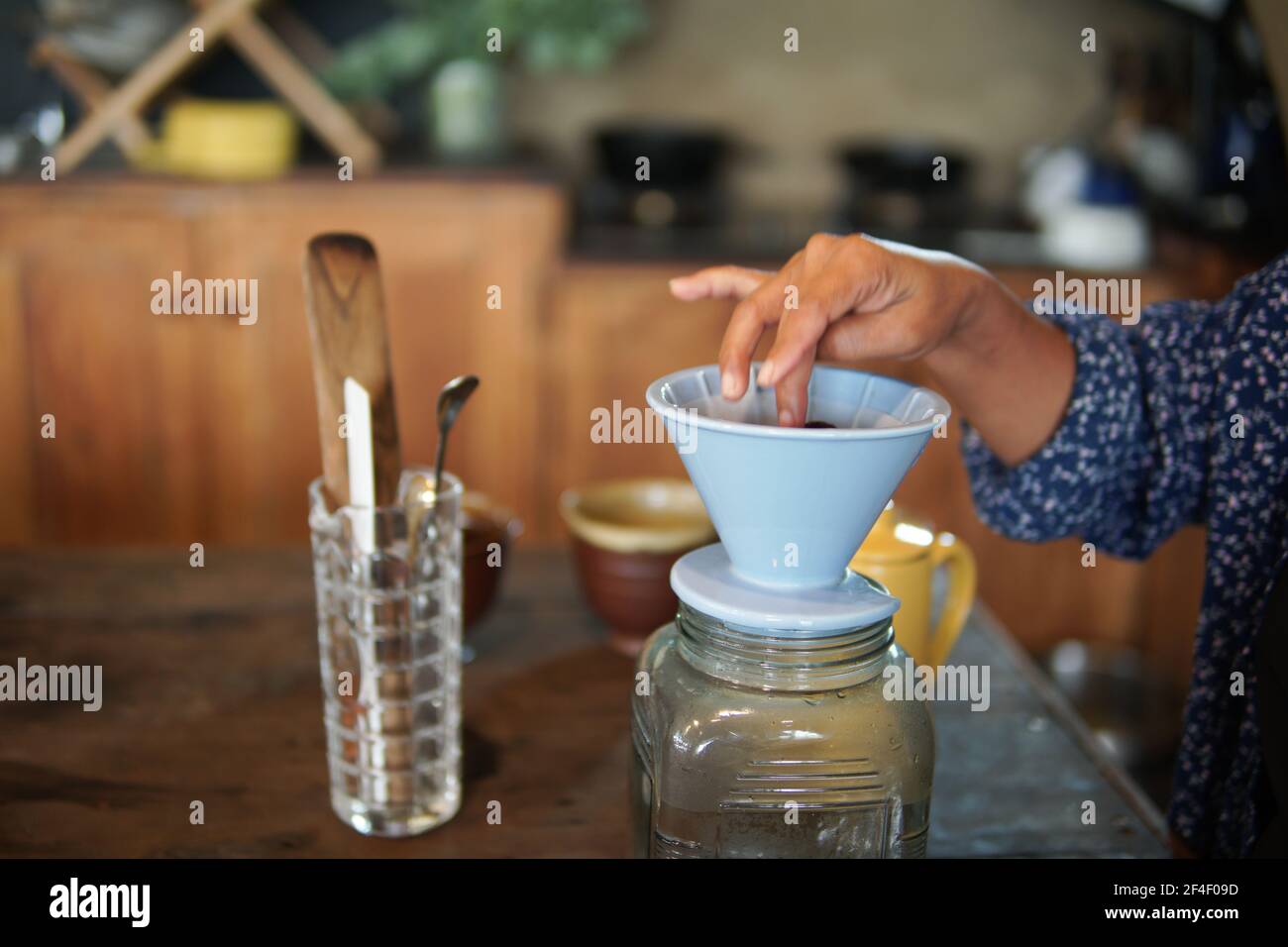 barista preparing brewing coffee with coffee maker and drip kettle ...