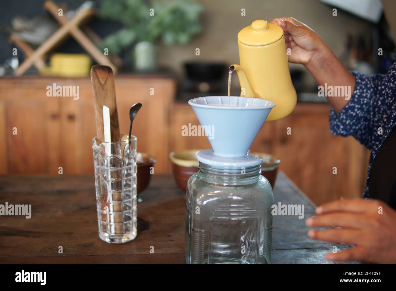 barista preparing brewing coffee with coffee maker and drip kettle ...