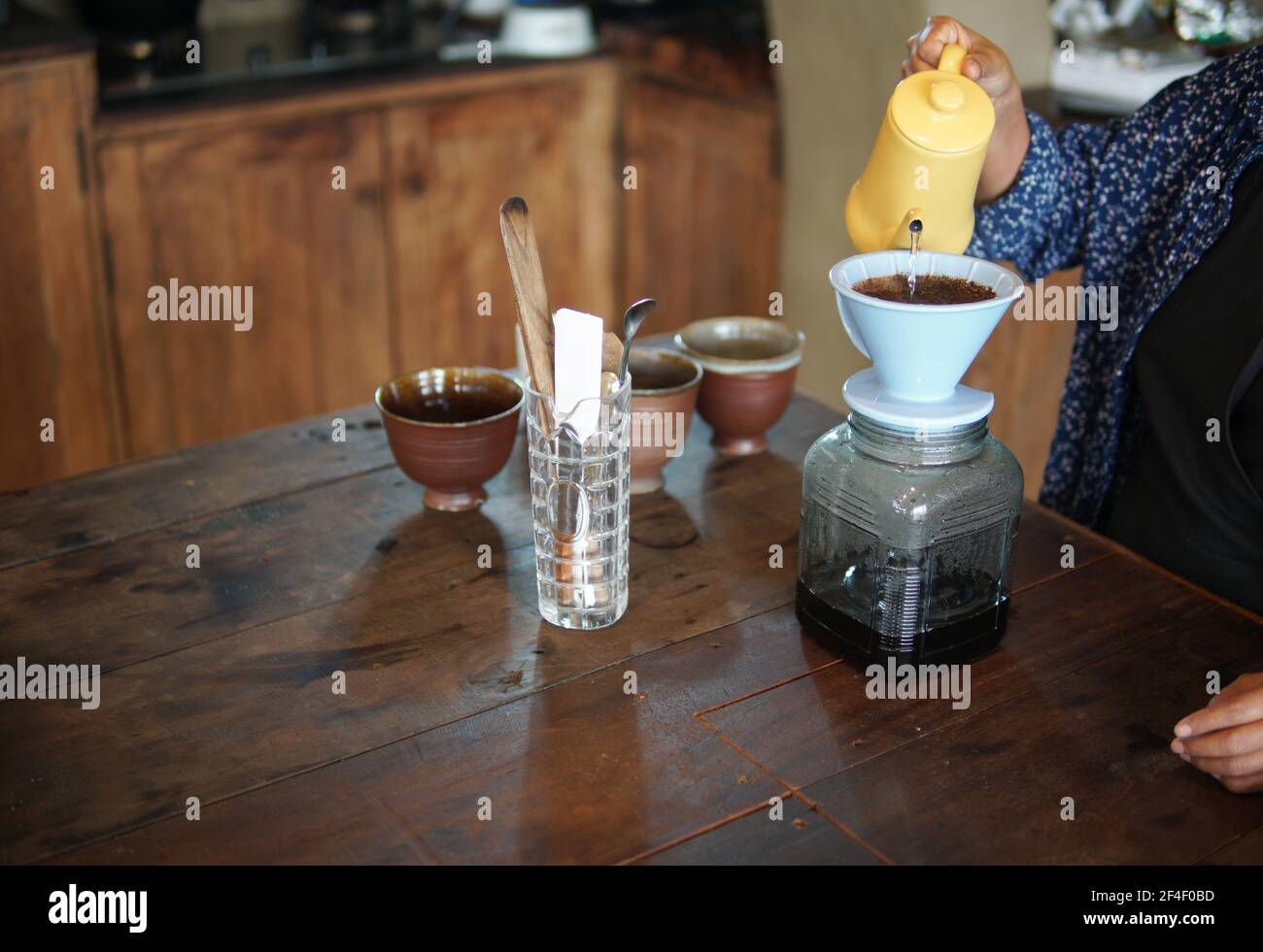 barista preparing brewing coffee with coffee maker and drip kettle ...