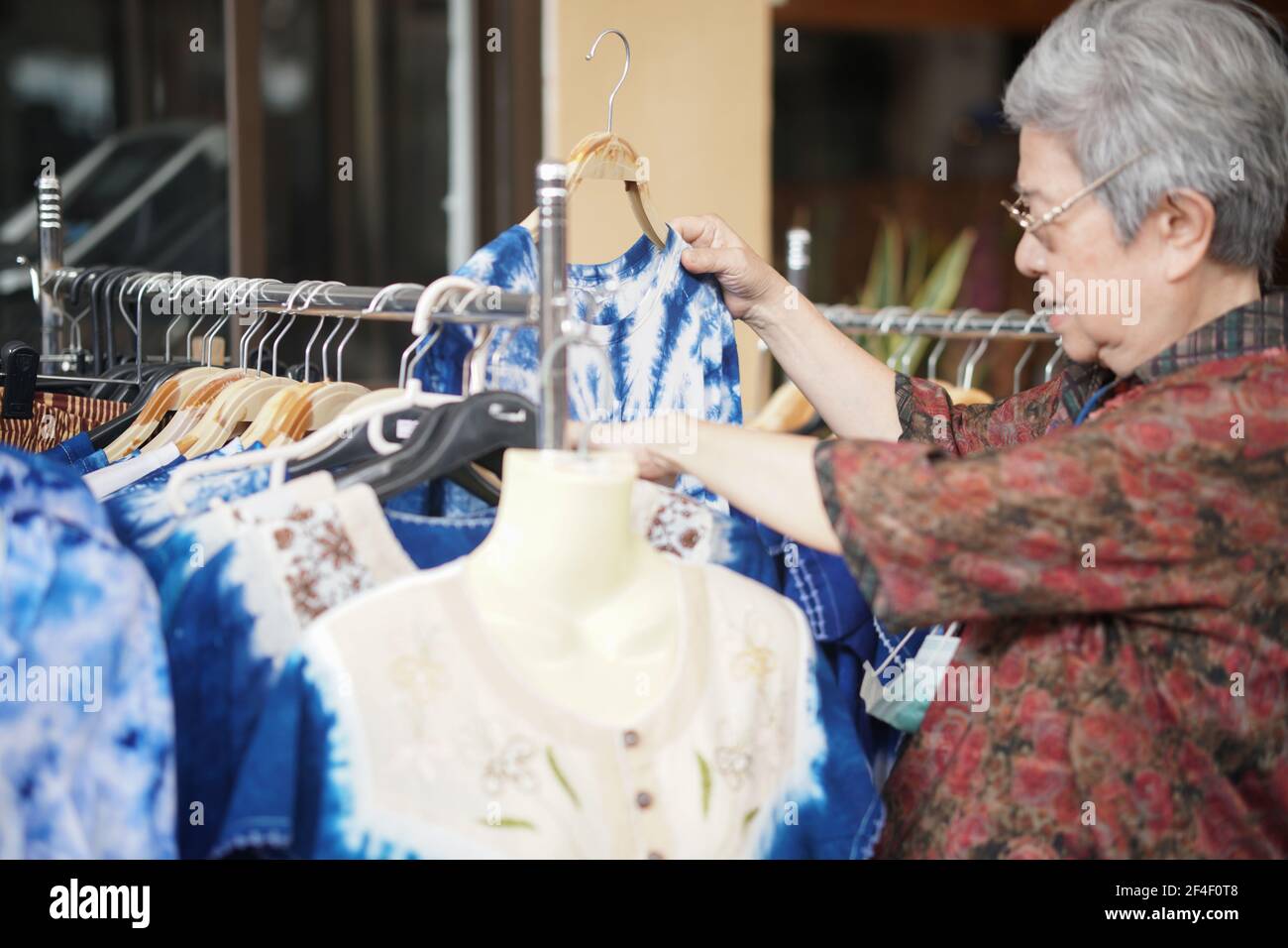 old senior elder woman choosing clothes at store shop mall Stock Photo ...