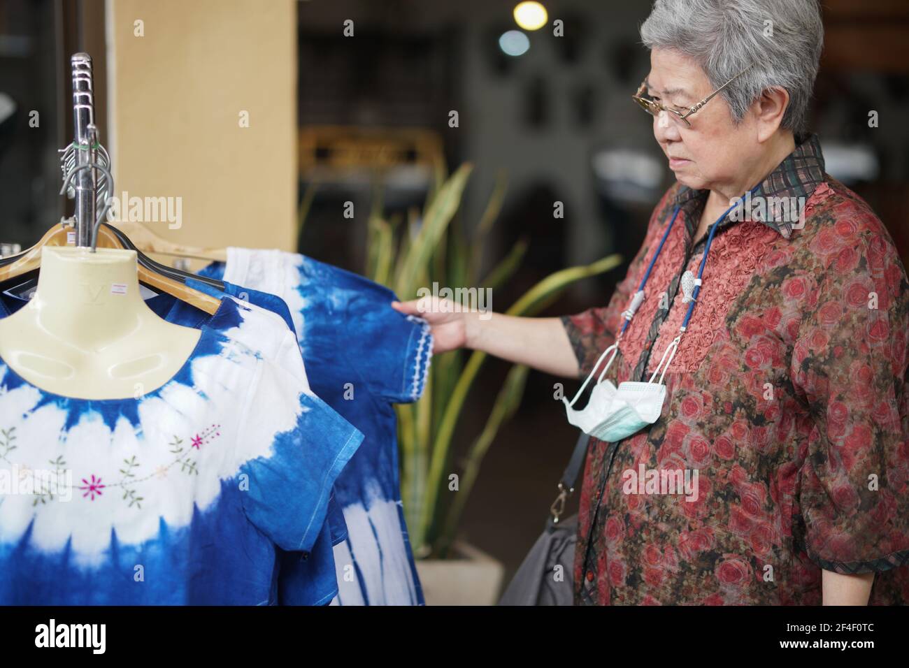 old senior elder woman choosing clothes at store shop mall Stock Photo ...