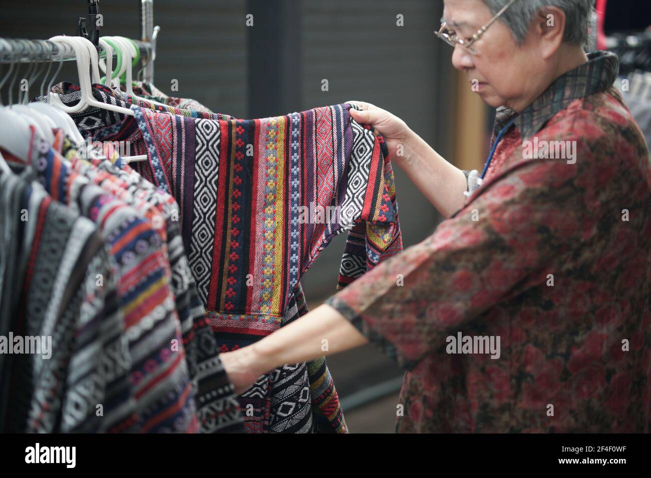 old senior elder woman choosing clothes at store shop mall Stock Photo ...