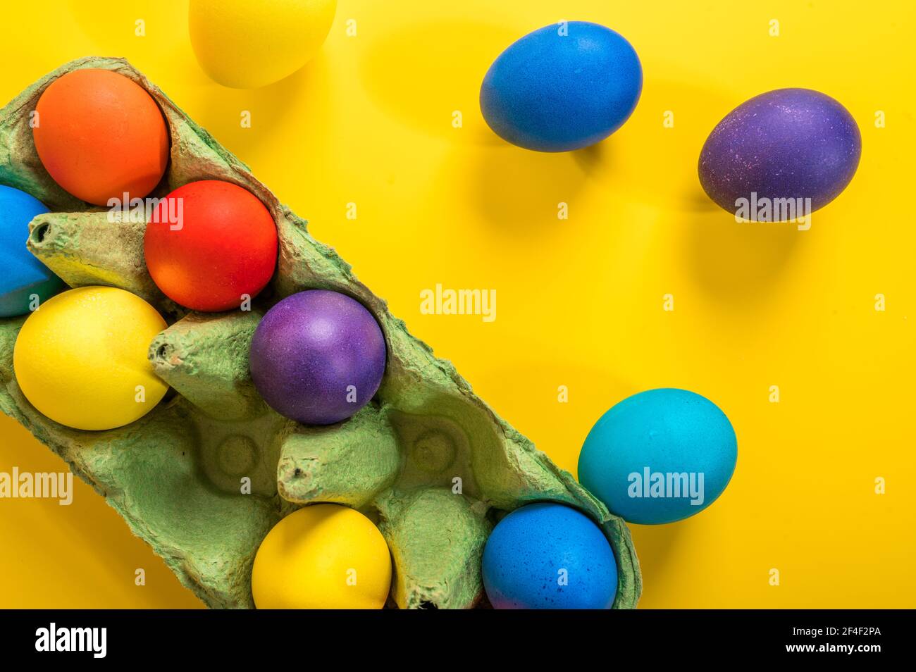 Multi-colored Easter eggs in an egg tray. Minimal concept Stock Photo ...