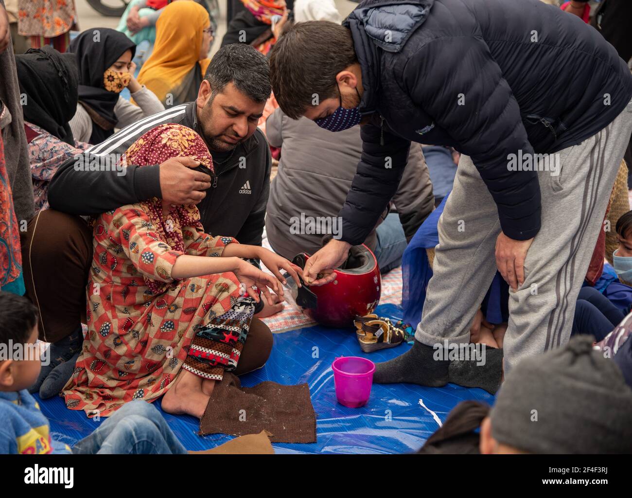 Srinagar, India. 21st Mar, 2021. A traditional health worker treats ...