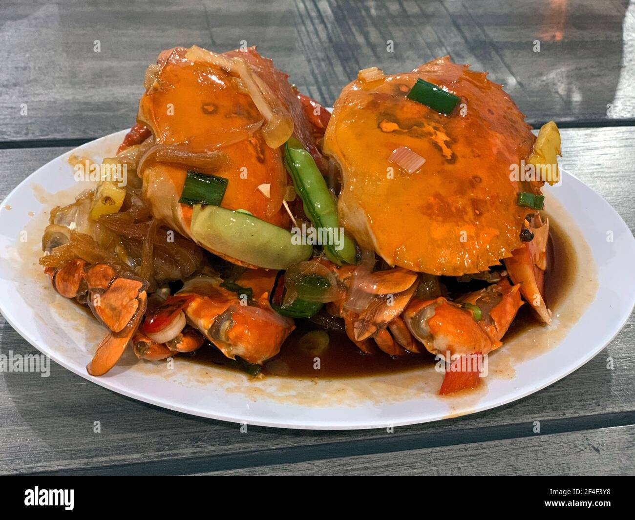 Indonesian sweet sour crab served on a plate Stock Photo - Alamy