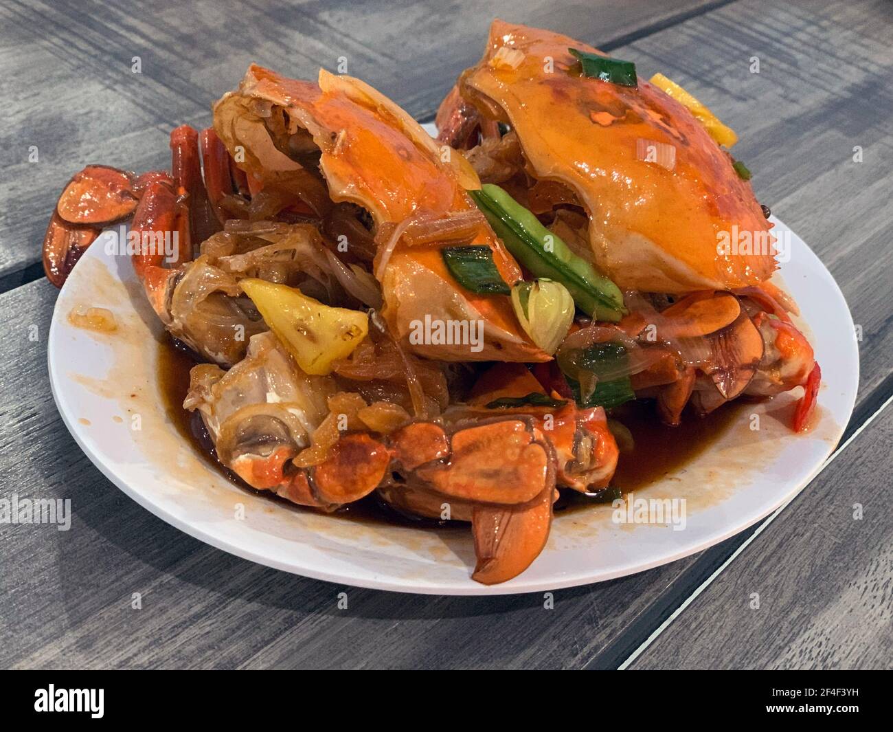 Indonesian sweet sour crab served on a plate Stock Photo - Alamy