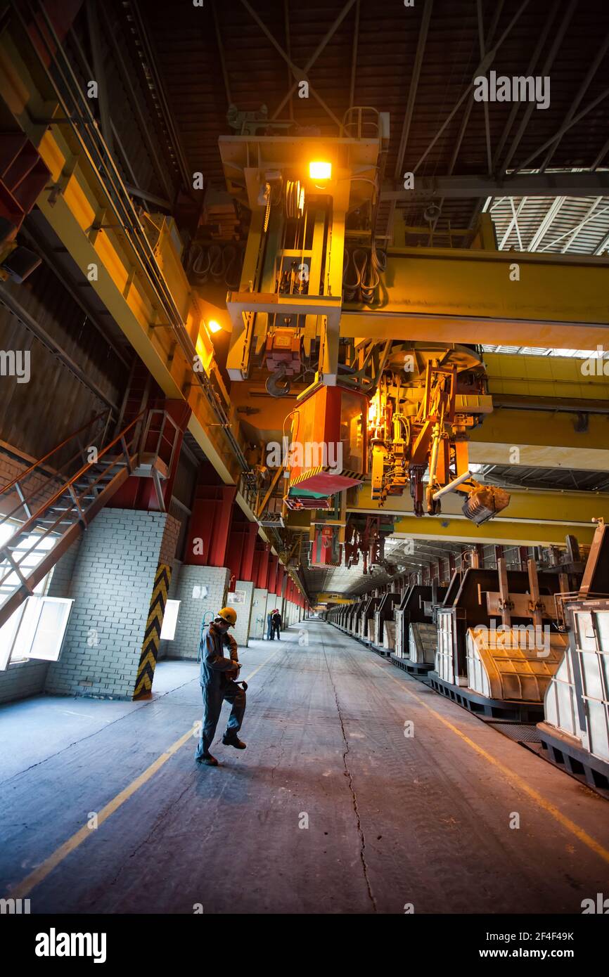 Aluminum electrolysis plant. Slag handling crane and electrolysis baths ...