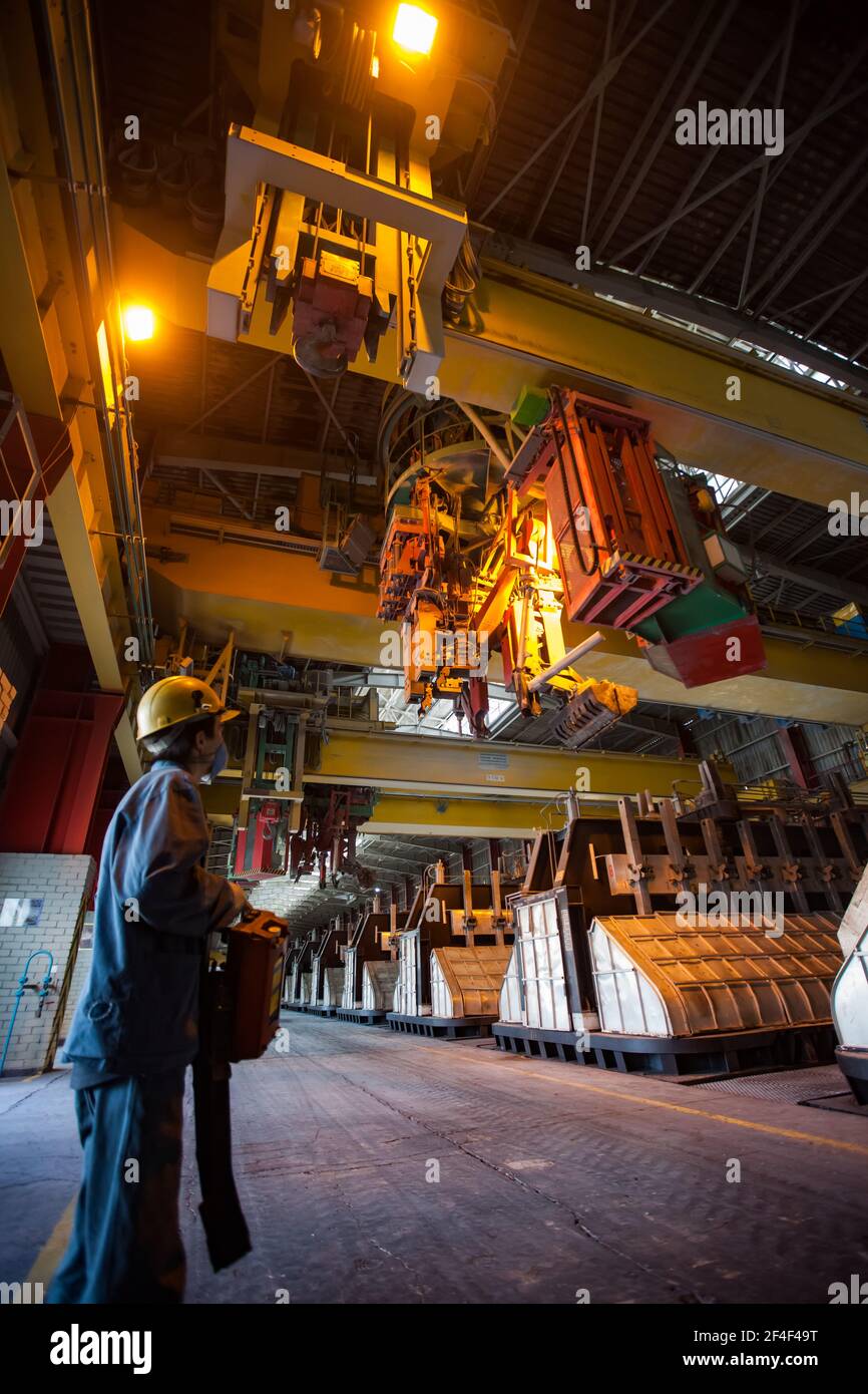 Aluminum electrolysis plant. Slag handling crane and electrolysis baths ...