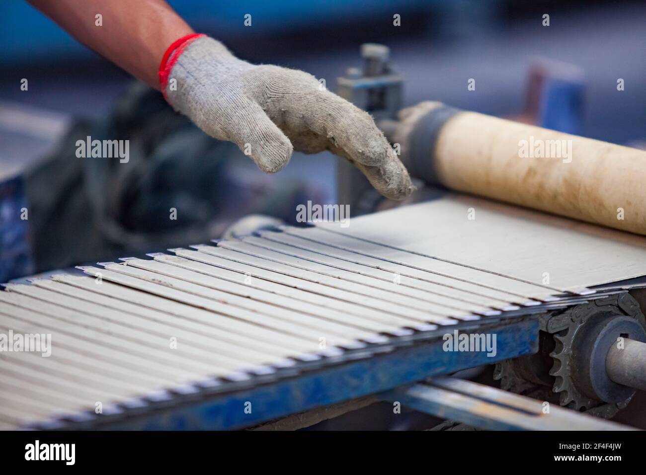 Worker sorting new plumb battery jumpers. Accumulator recycling plant ...