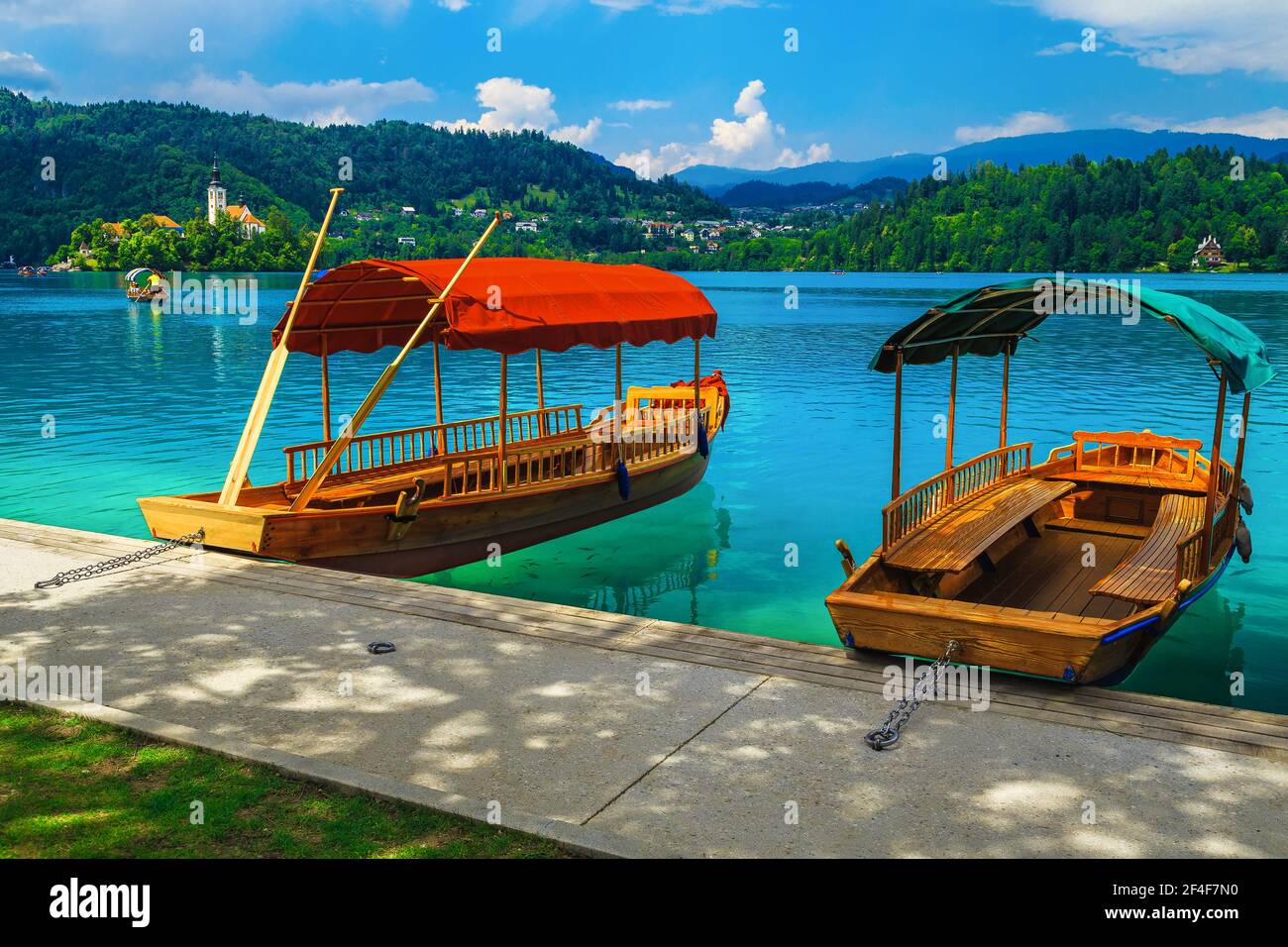 Famous traditional wooden Pletna boat moored at the pier. Rowing Pletna ...