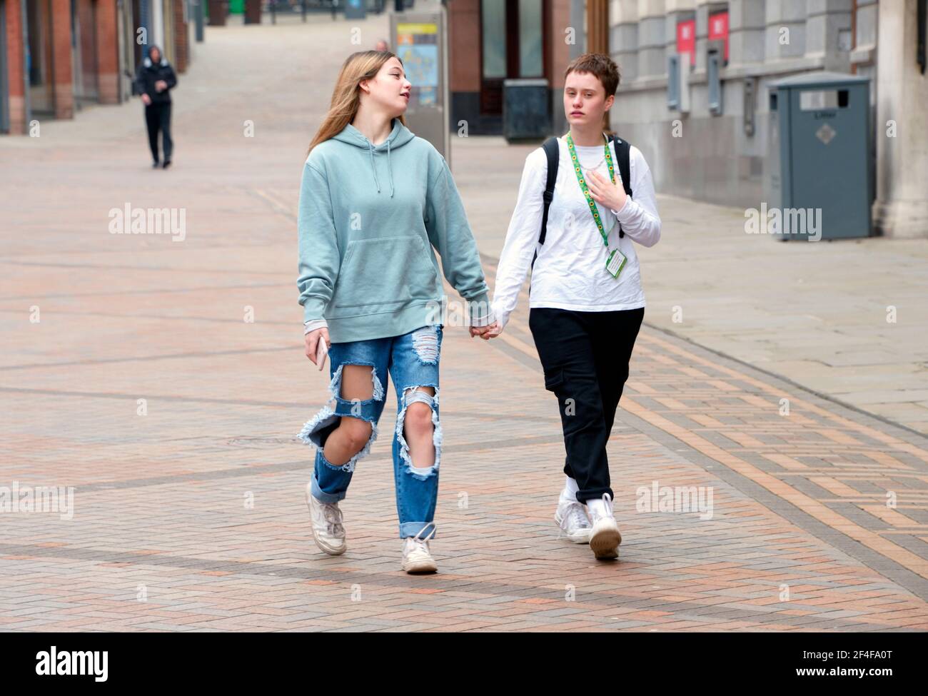 Couple, females, walking holding hands during lockdown Stock Photo - Alamy