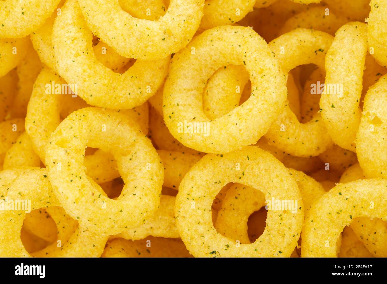 Beer snacks. Background of corn rings of sticks with cheese and green ...
