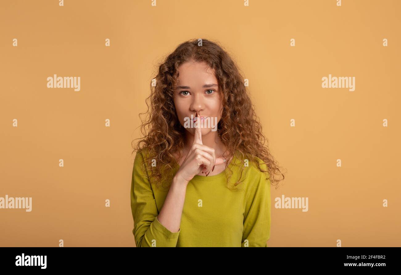 Facial expressions, privacy, secret information and gesture Stock Photo ...