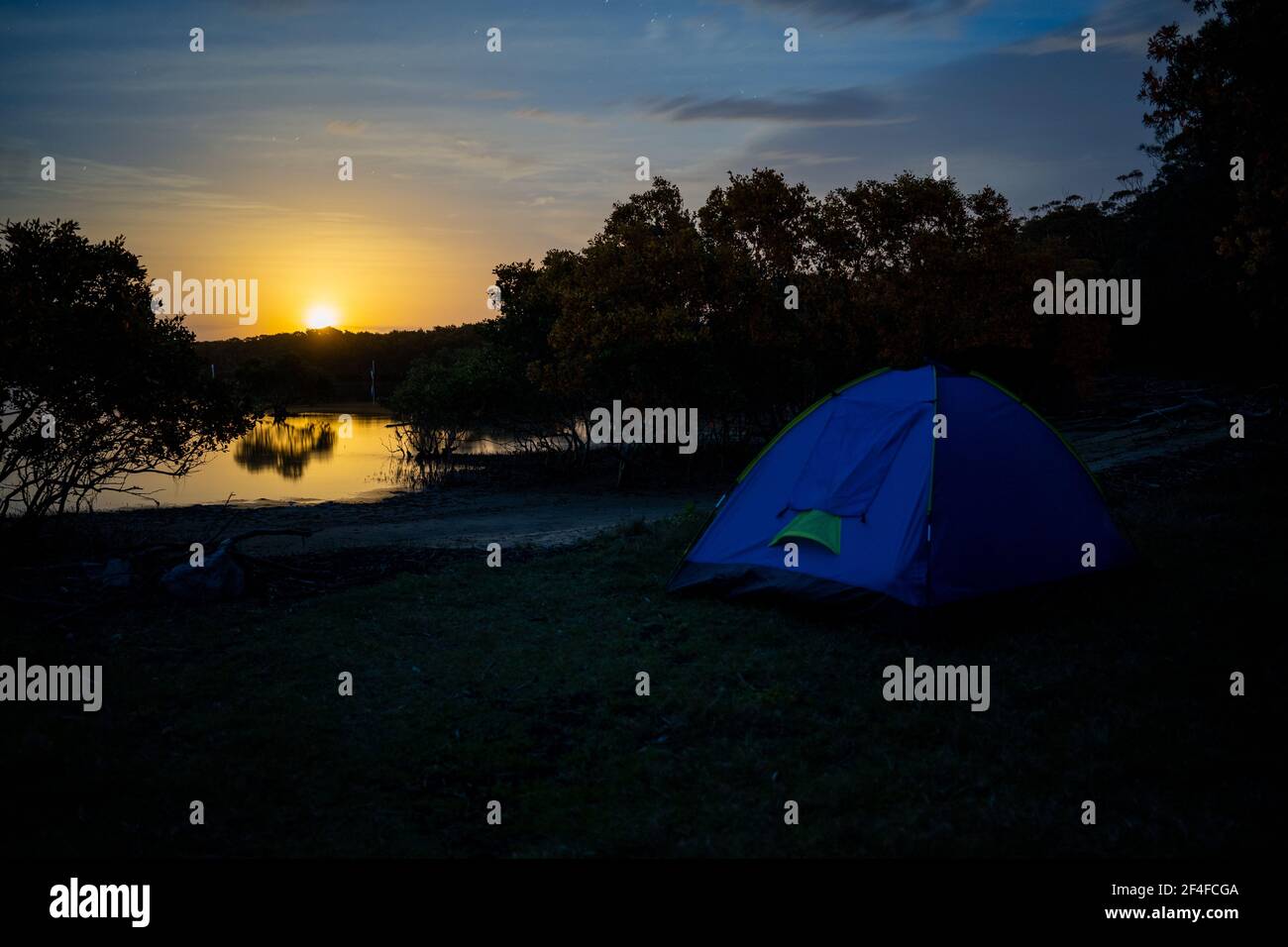 Long exposure moon rise with reflection at a camping site Stock Photo ...