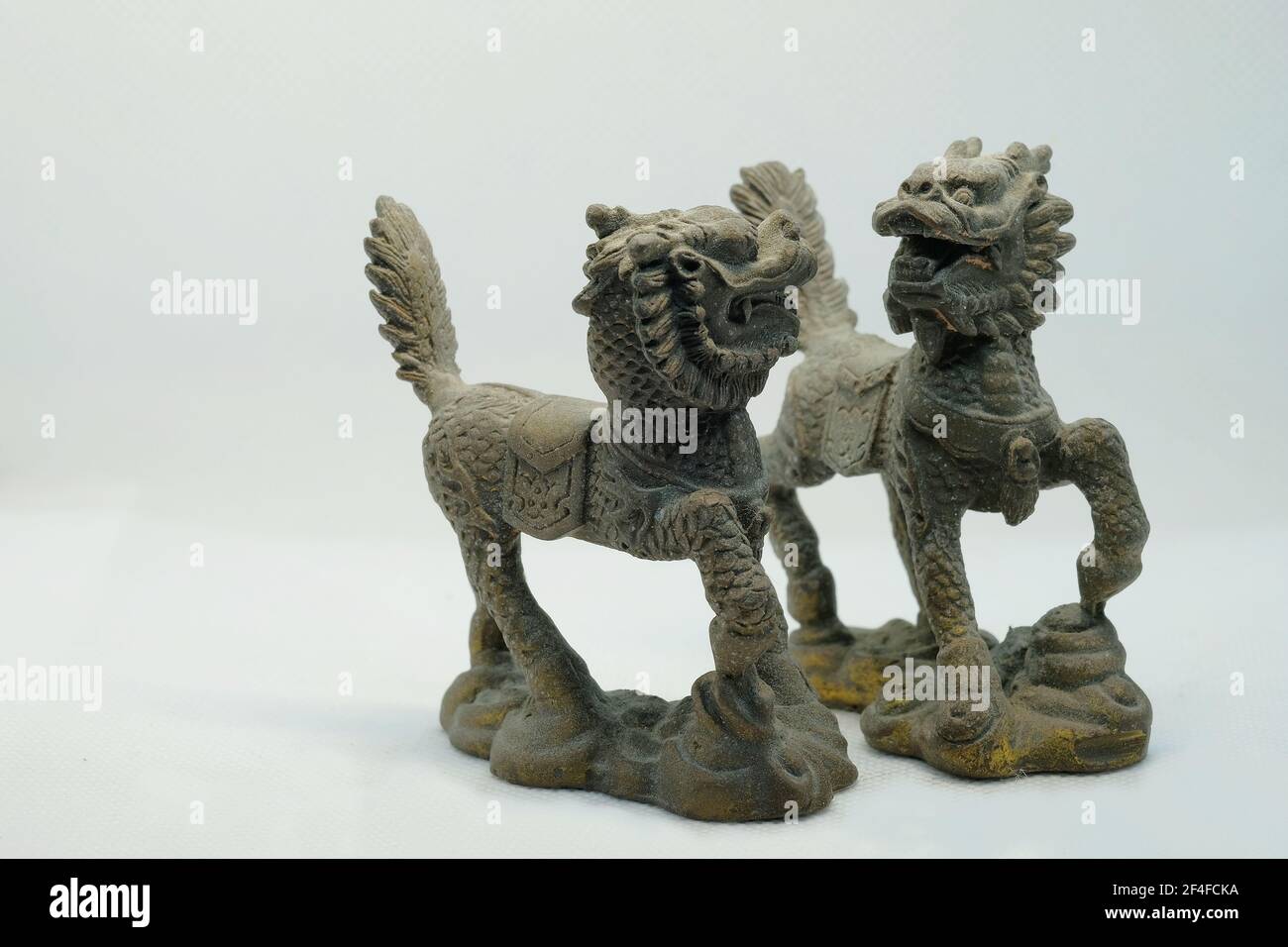 A pair of mythical Chinese bronze Qilin figurines, with head of a ...