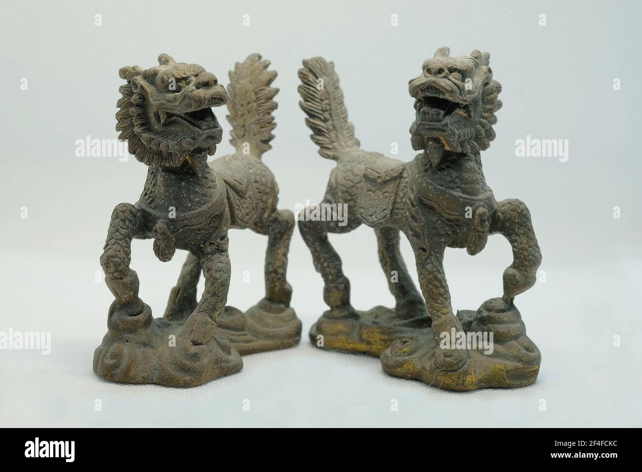 A pair of mythical Chinese bronze Qilin figurines, with head of a ...