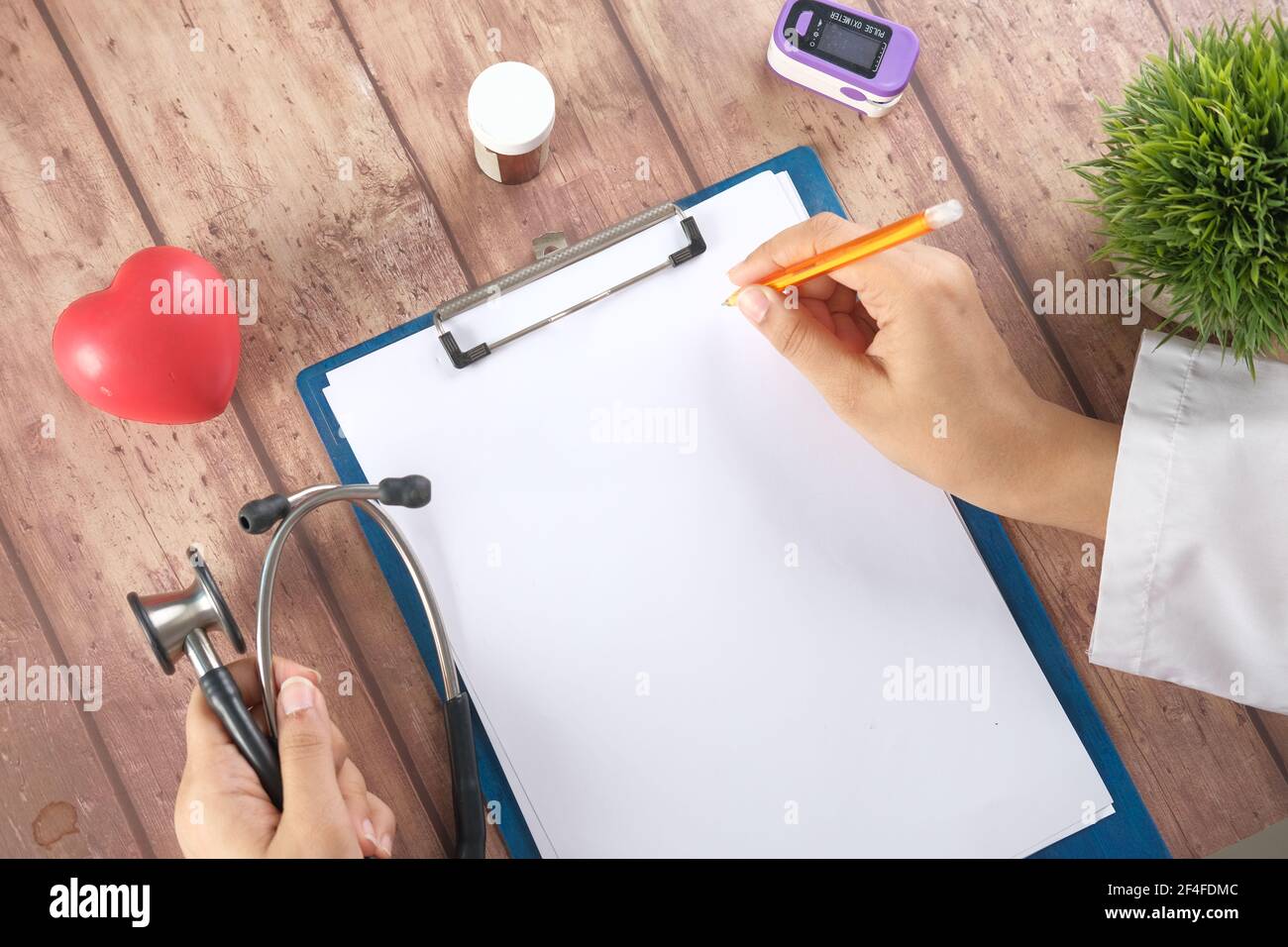 female doctor hand writing prescription on desk, top view Stock Photo ...