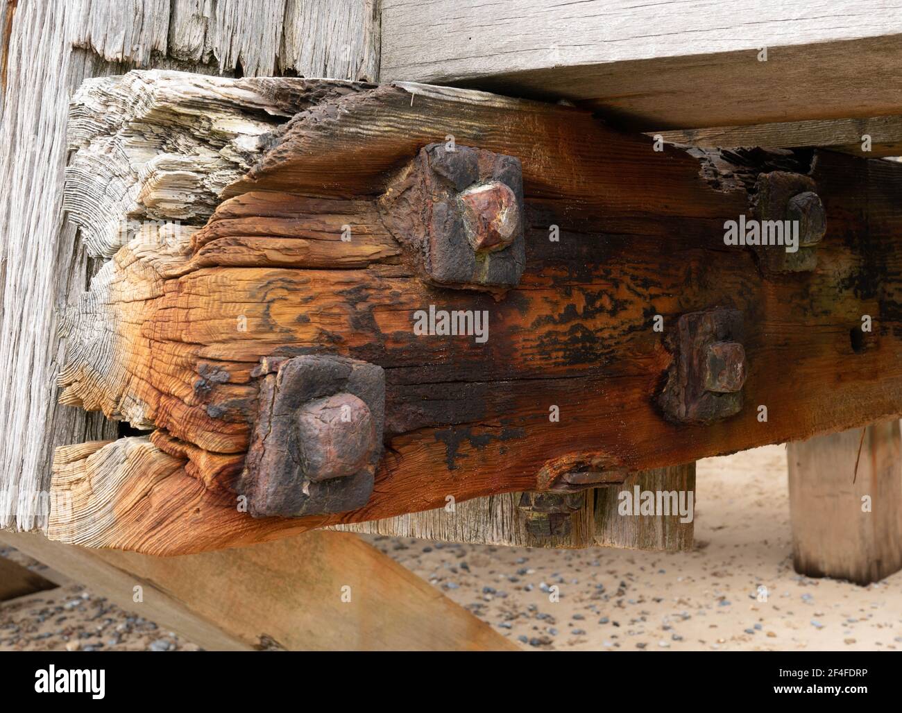 Decaying wooden beams on the end of a pier in norfolk england where the ...