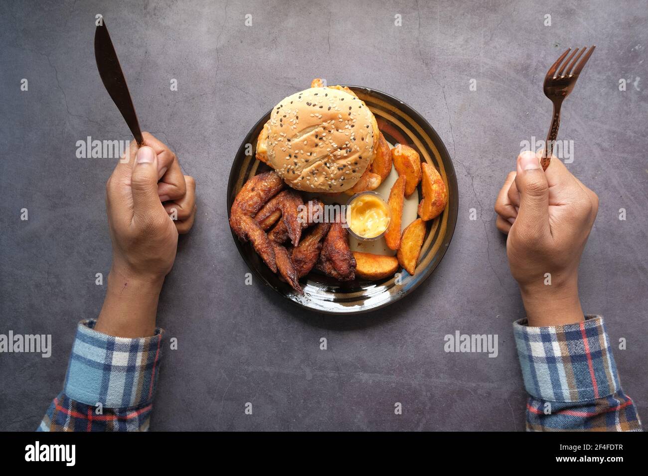 top view of man hand with knife waiting for eating junk food Stock ...