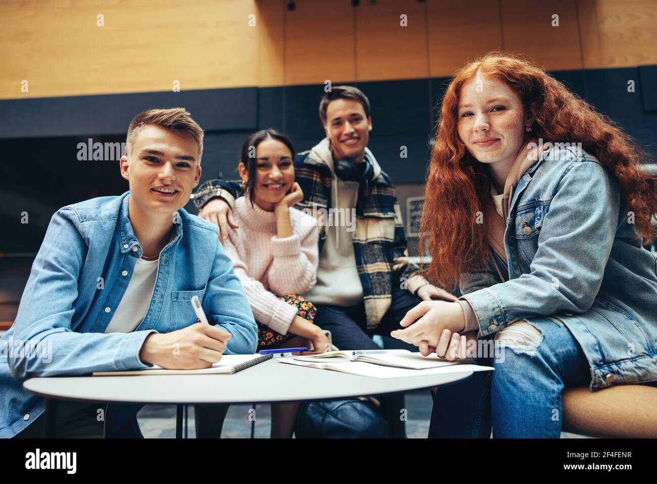 Group teenagers sitting table hi-res stock photography and images - Alamy