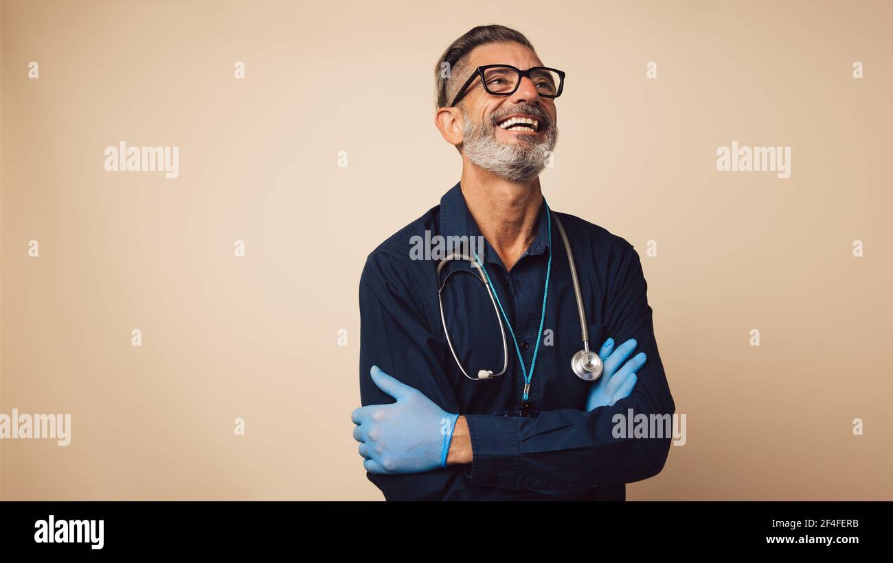 Portrait of a cheerful general practitioner with stethoscope wearing ...