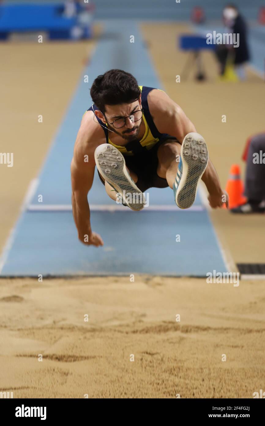 ISTANBUL, TURKEY - JANUARY 30, 2021: Undefined athlete long jumping ...
