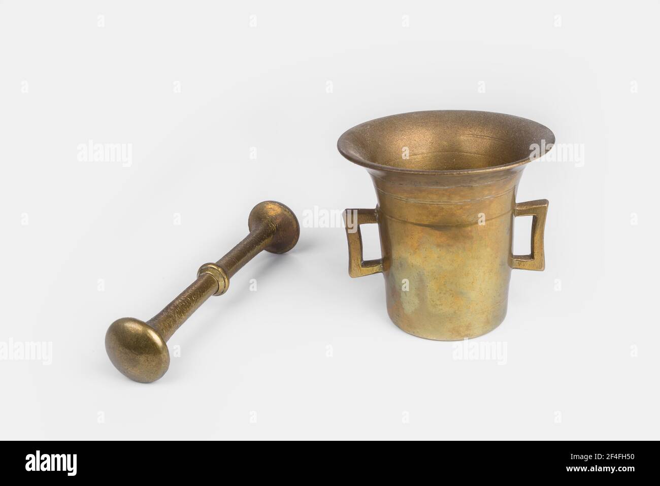 Golden Mortar and pestle set on a white background Stock Photo - Alamy