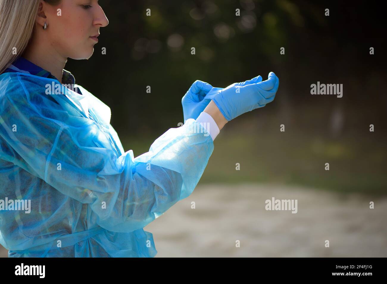 Girl puts on rubber gloves before garbage collection Stock Photo - Alamy