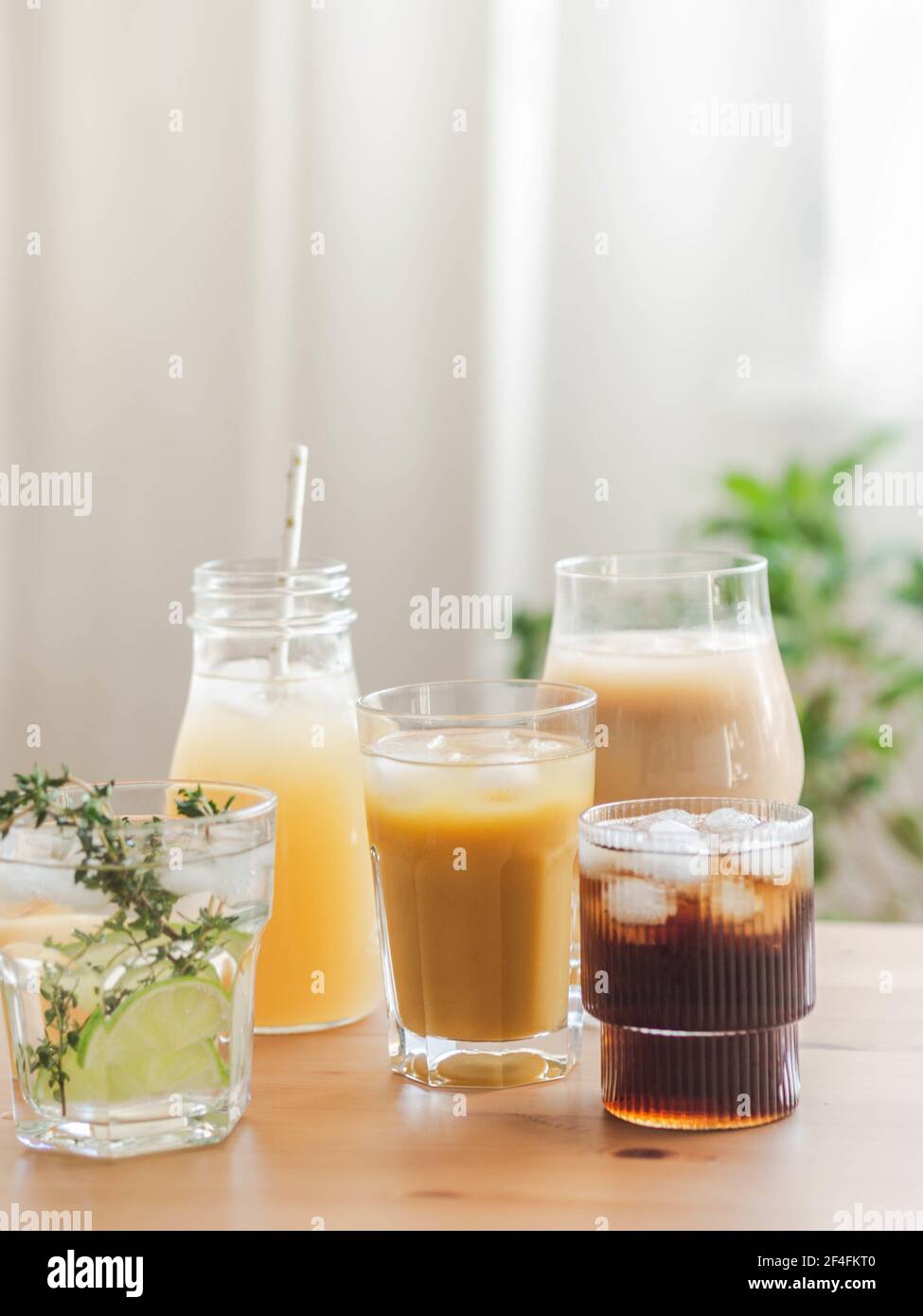 Various refreshing non-alcoholic drinks in glasses with ice. Fruit ...