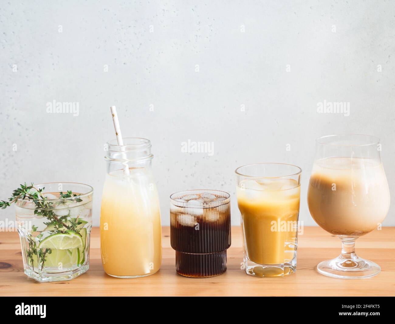 Various refreshing non-alcoholic drinks in glasses with ice. Fruit ...