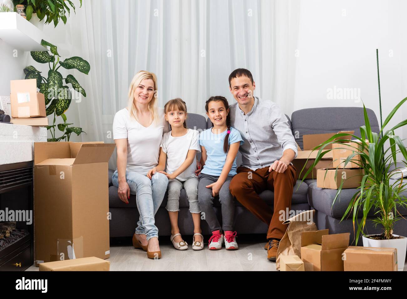 concept housing a young family. Mother father and children in new house ...