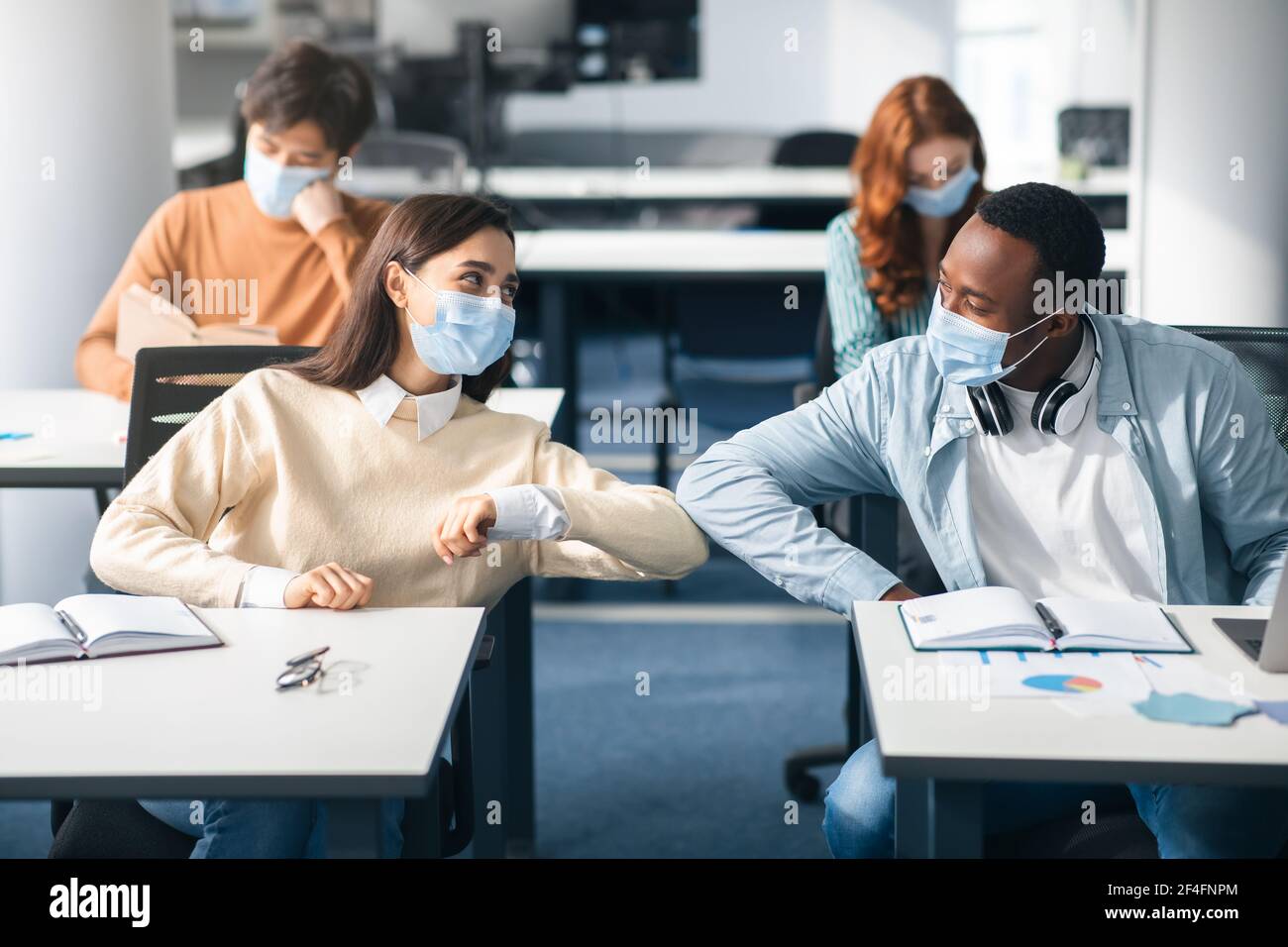 Student bumping elbows hi-res stock photography and images - Alamy