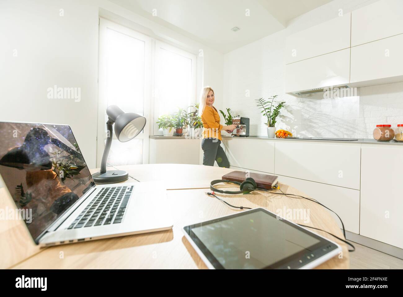 laptop on wood table in modern kitchen room Stock Photo - Alamy