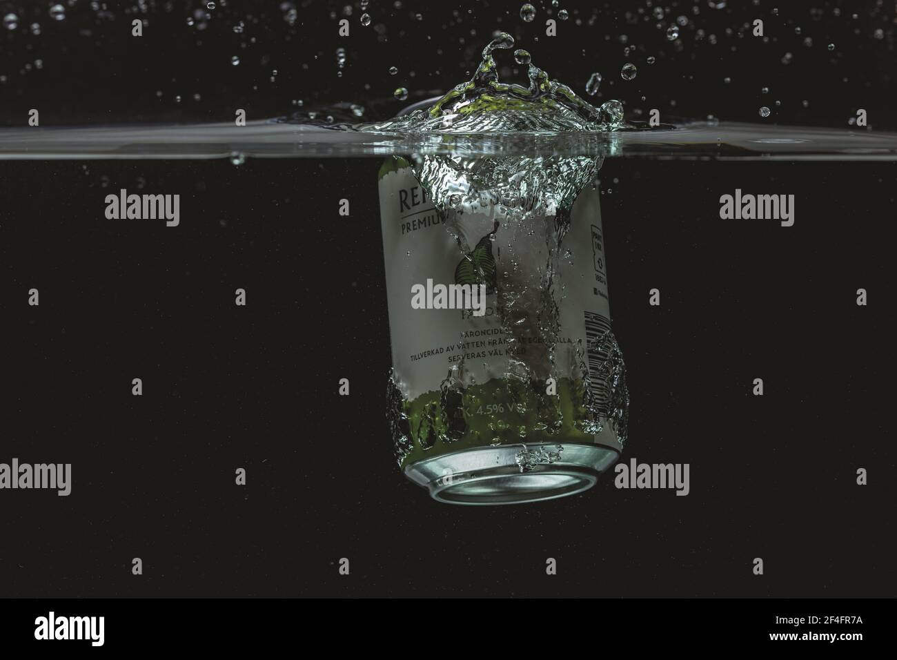 Close up view of can falling in water. Pear sider Stock Photo - Alamy