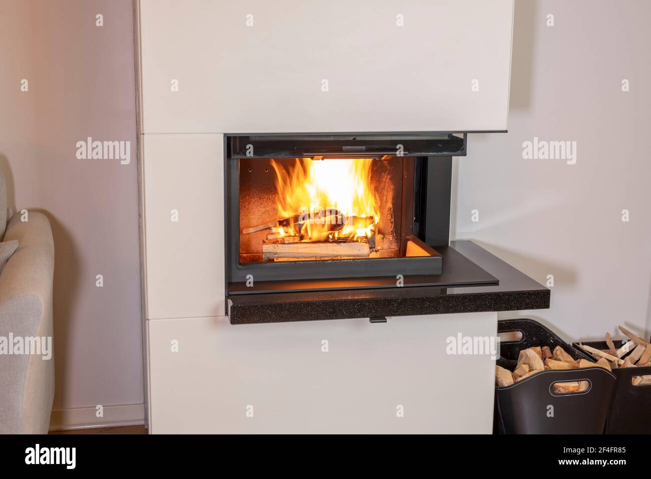 Beautiful view of interior of modern living room. View of burning wood ...