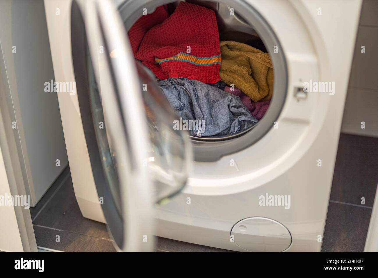 Close up view of washed laundry in a laundry machine. Home routine ...