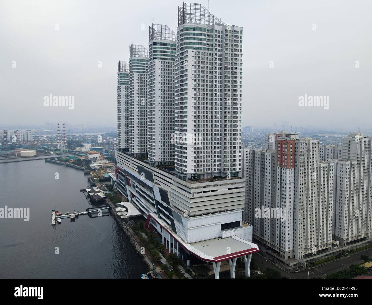 Aerial drone view of Muara Angke Beach with wooden boats leaning beside ...
