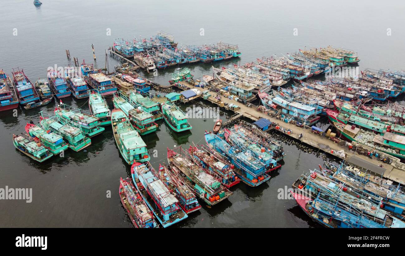 Aerial drone view of Muara Angke Beach with wooden boats leaning beside ...