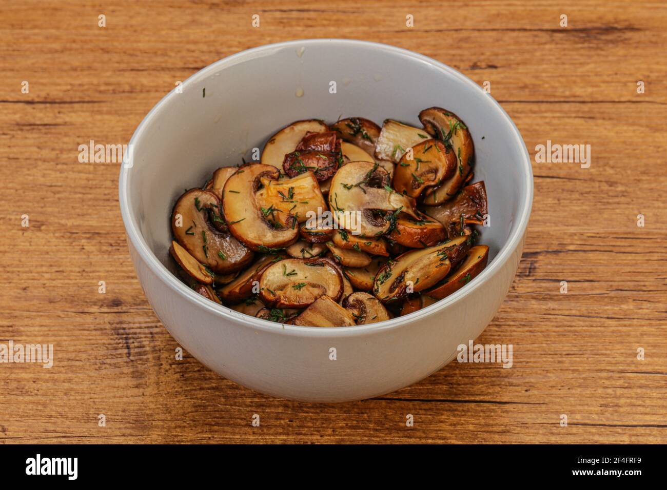 Roasted champignon with herbs and spices in the bowl Stock Photo - Alamy