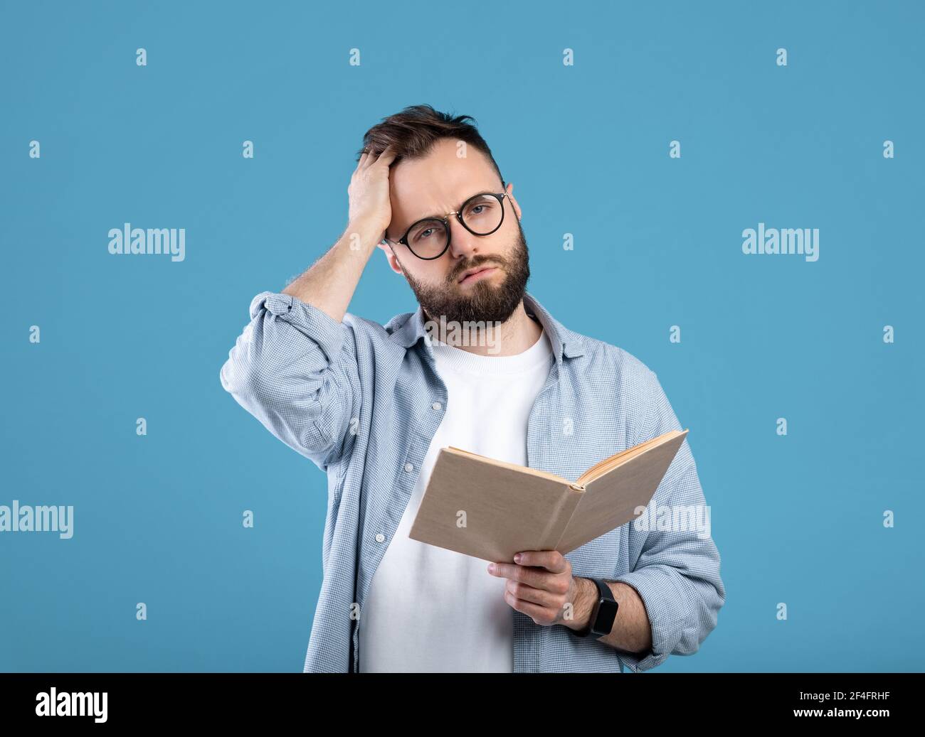 Studying is hard. Young bearded guy having problem understanding ...