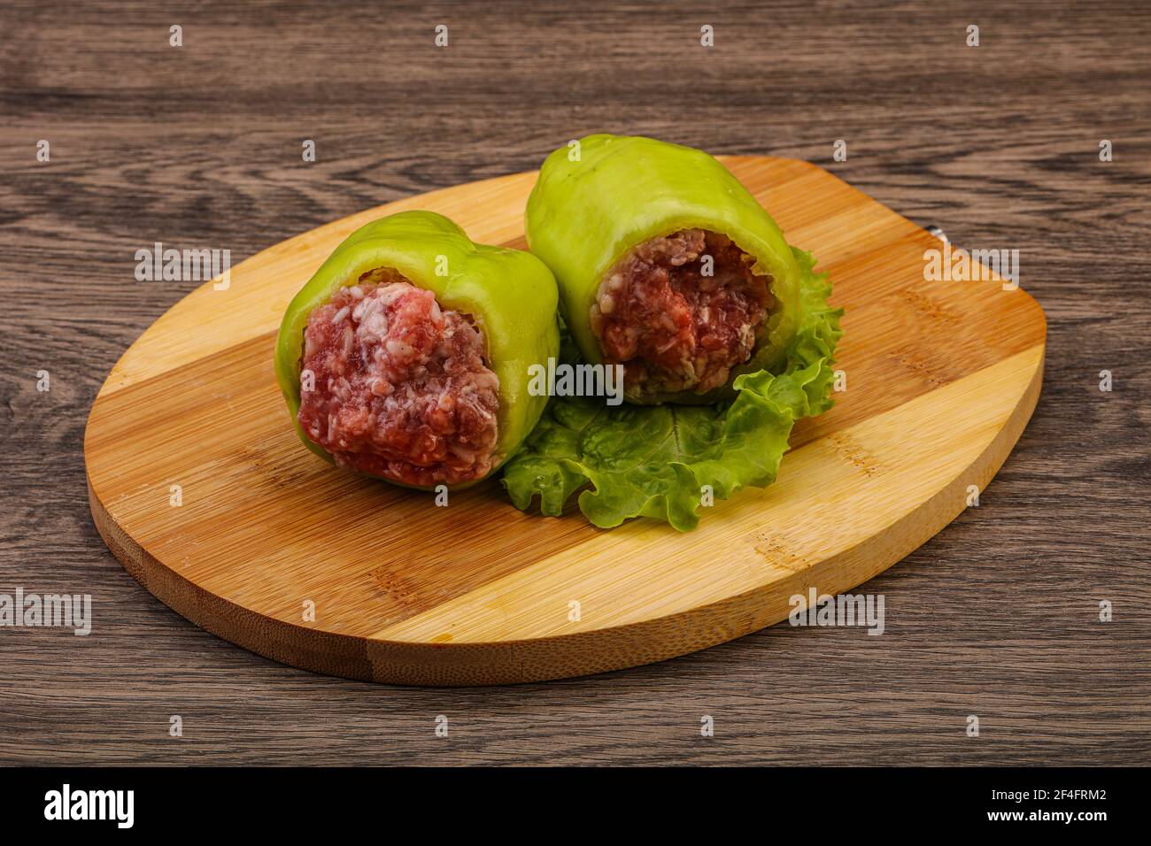 Raw stuffed green bell pepper with meat Stock Photo - Alamy