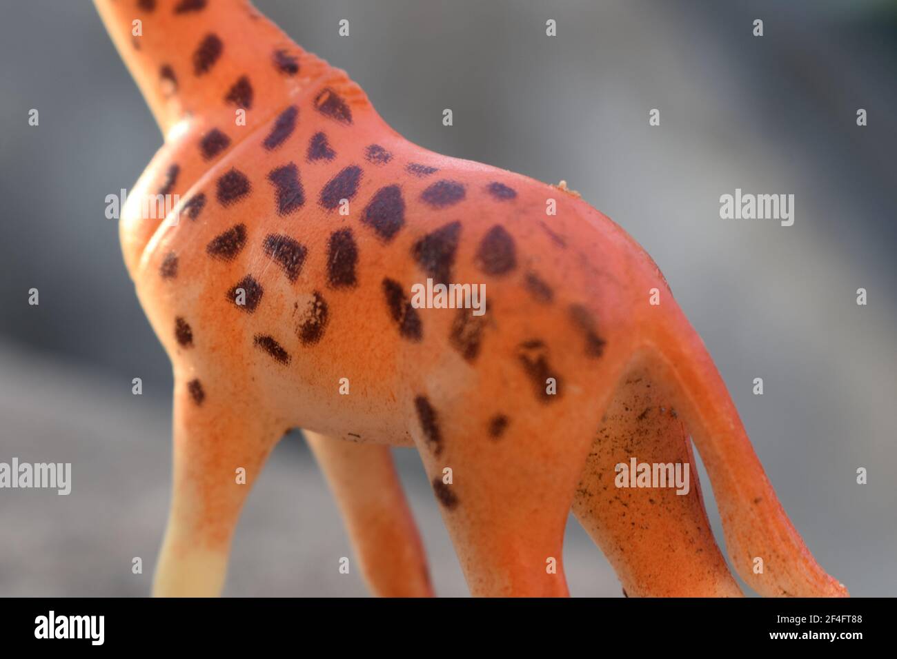 Beautiful miniature giraffe standing up made of plastic. Selective ...