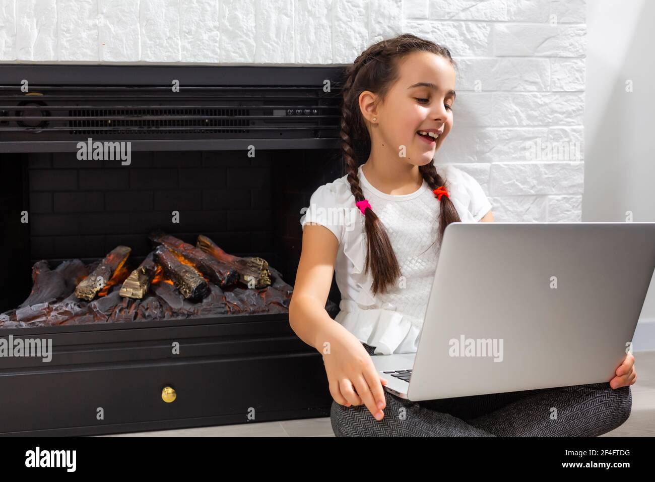Kids distance learning. Cute little girl using laptop at home ...