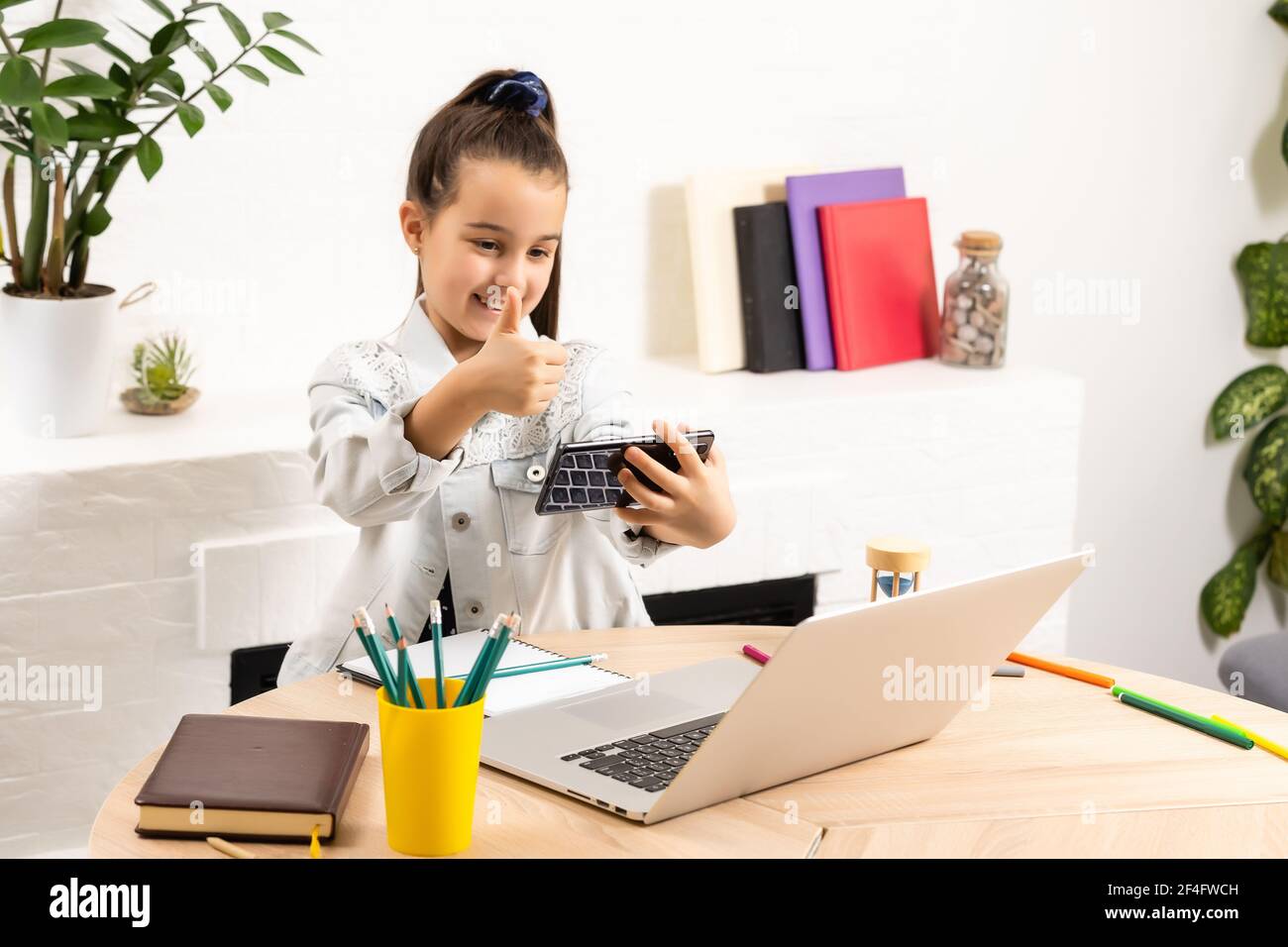 people, children and technology concept - girl with laptop computer and ...
