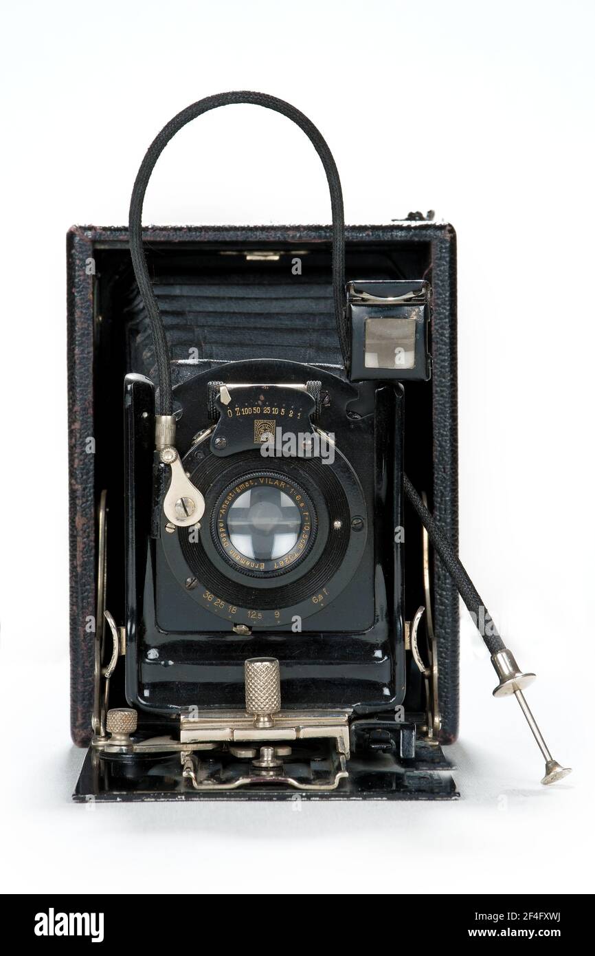 Old, antique folding camera, frontal, isolated on a white background ...