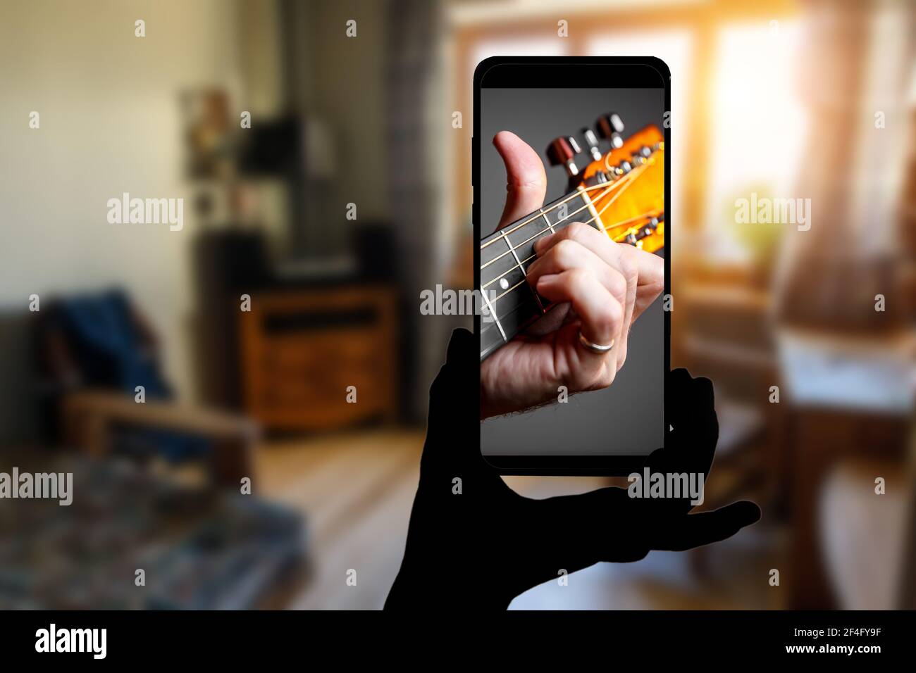 Guitar lessons tutorial with smart phone. Indoor screen shot of musical ...