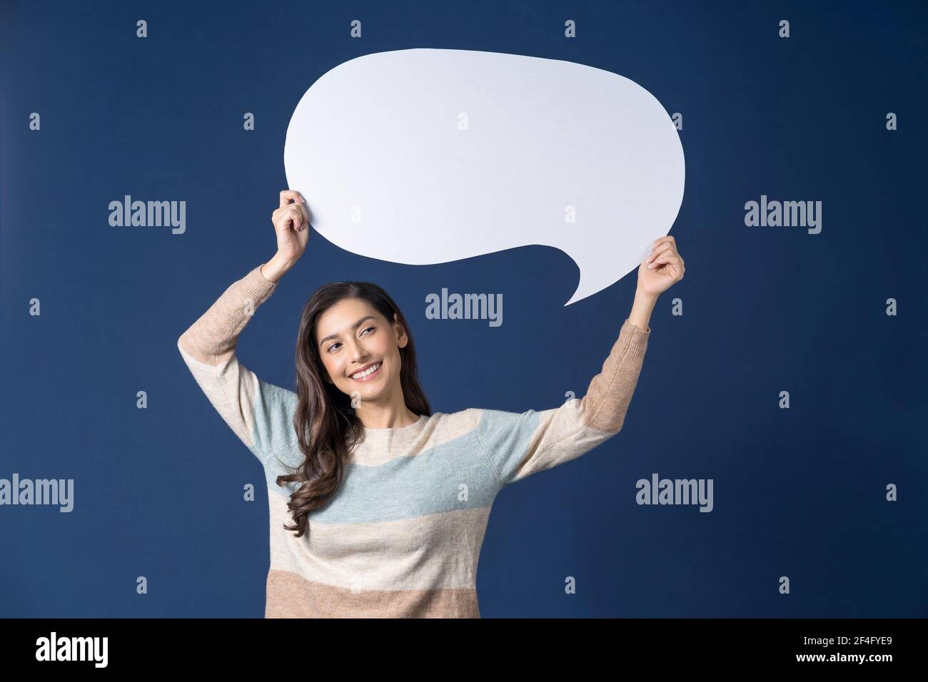Happy young smiling Asian woman holding copy space empty message ...