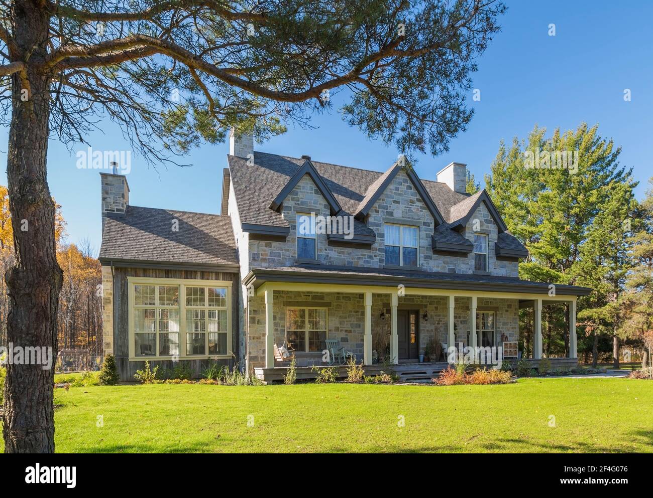 Tan, beige and grey nuanced natural cut stone and barn wood cladded ...