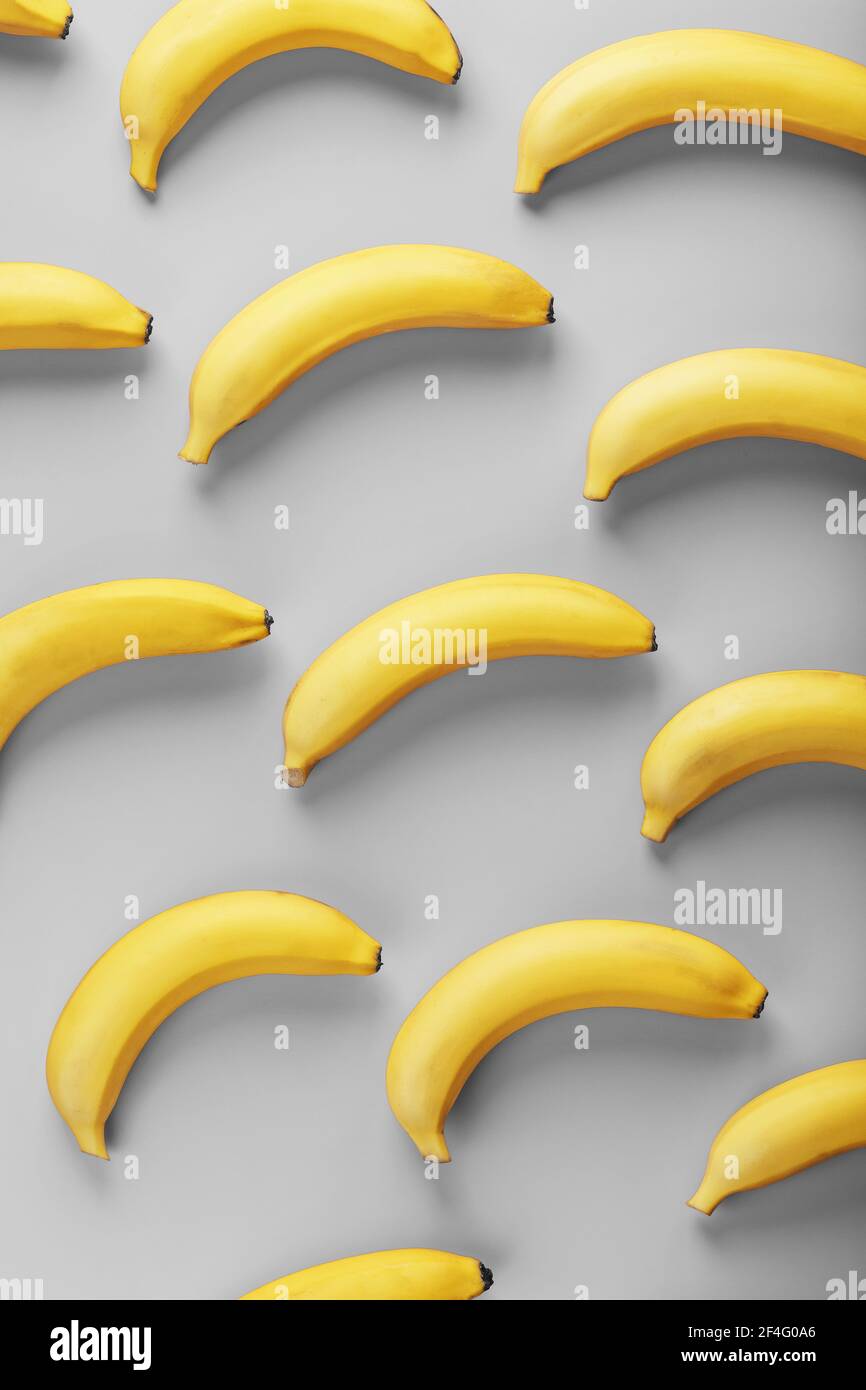 Bright pattern of yellow bananas on a gray background fashionable ...
